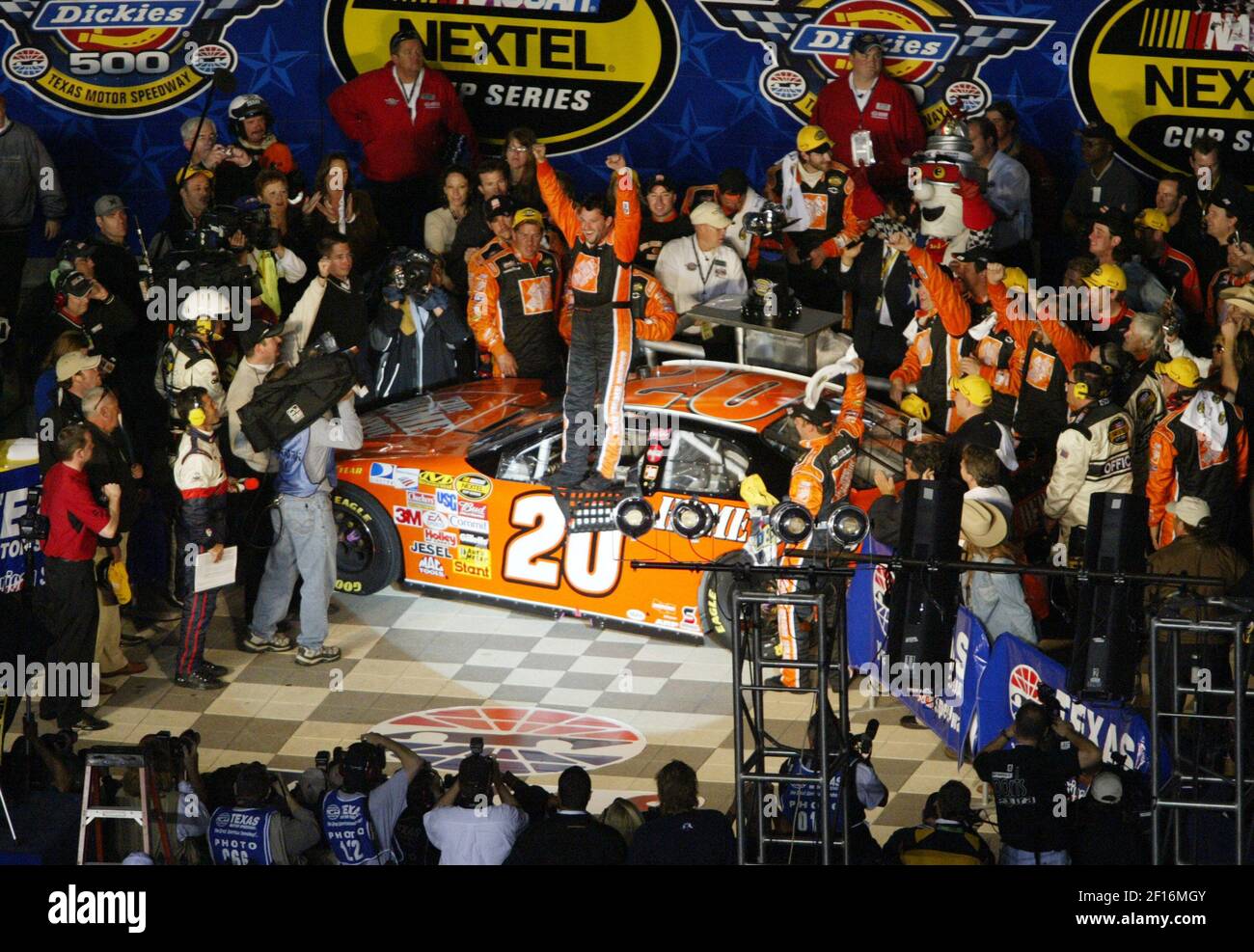 Tony Stewart celebrates in victory lane after winning the Dickies 500 ...