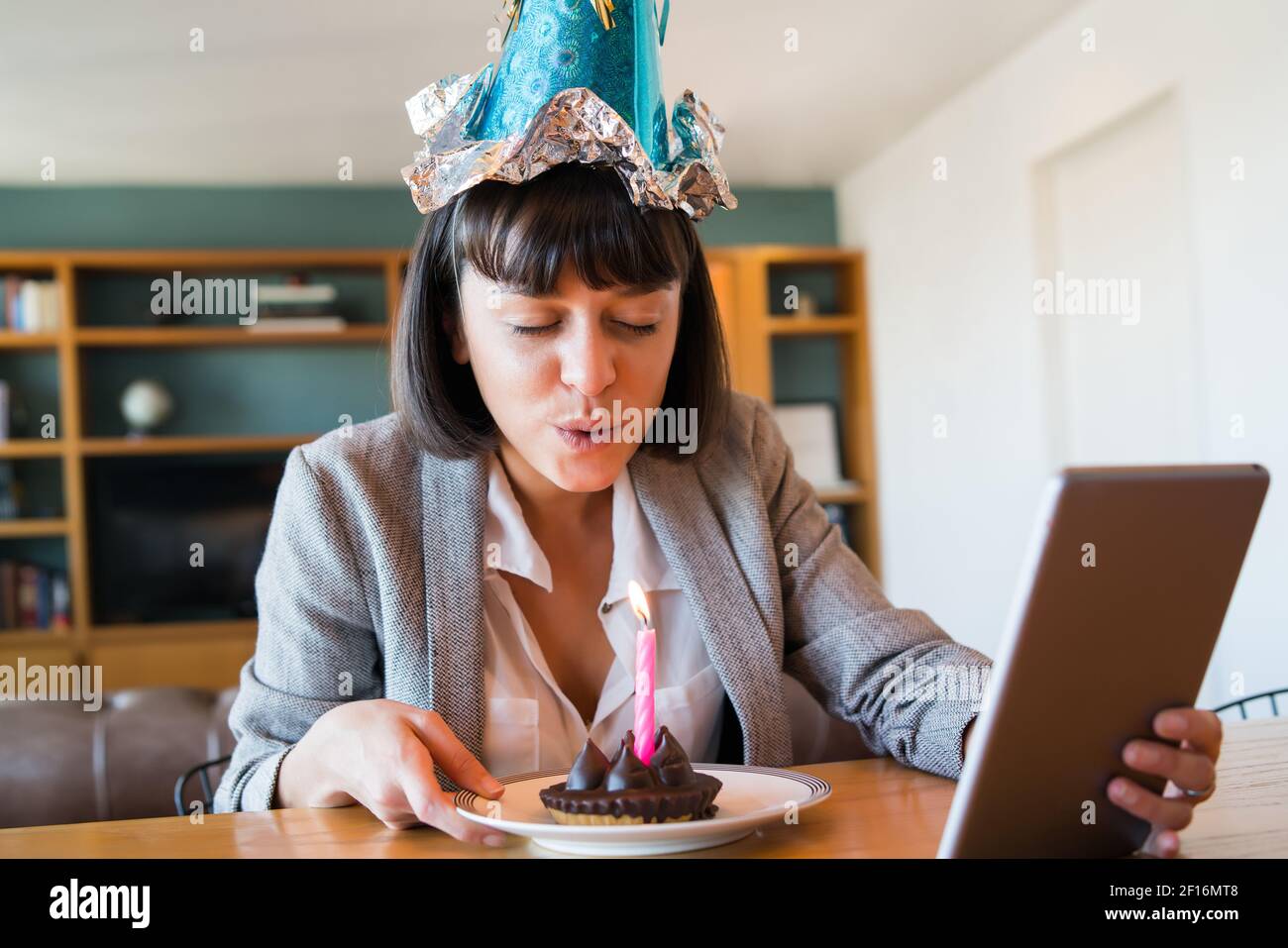 Woman celebrating her birthday on a video call Stock Photo - Alamy