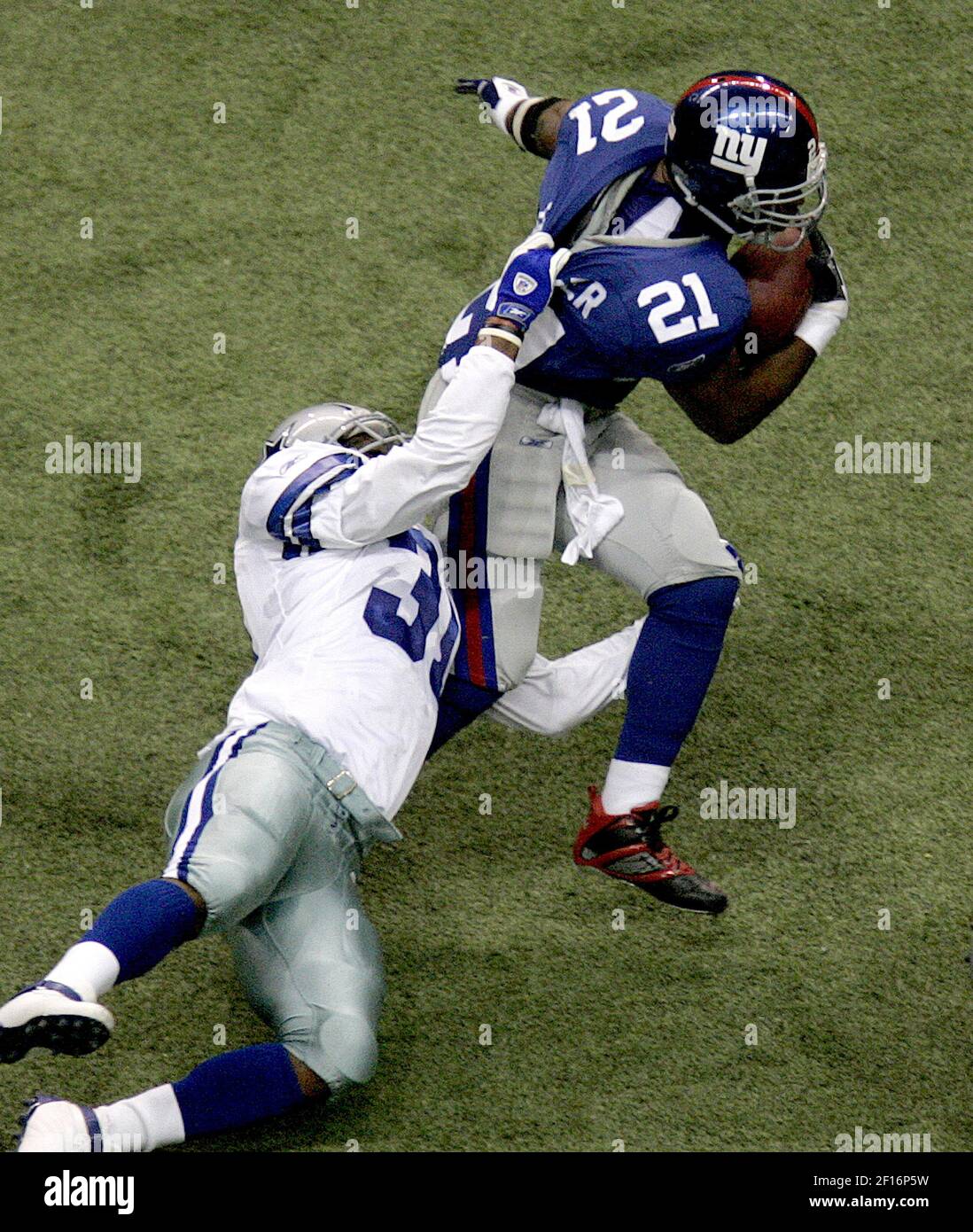 New York Giants' Tiki Barber drags Dallas Cowboys' Roy Williams for a ...