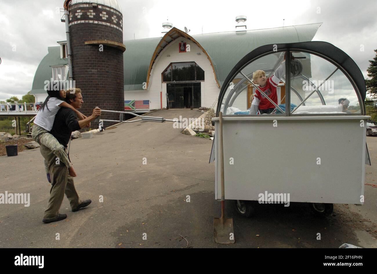 Scott Olson, the man responsible for Rollerblades, carries his daughter ...
