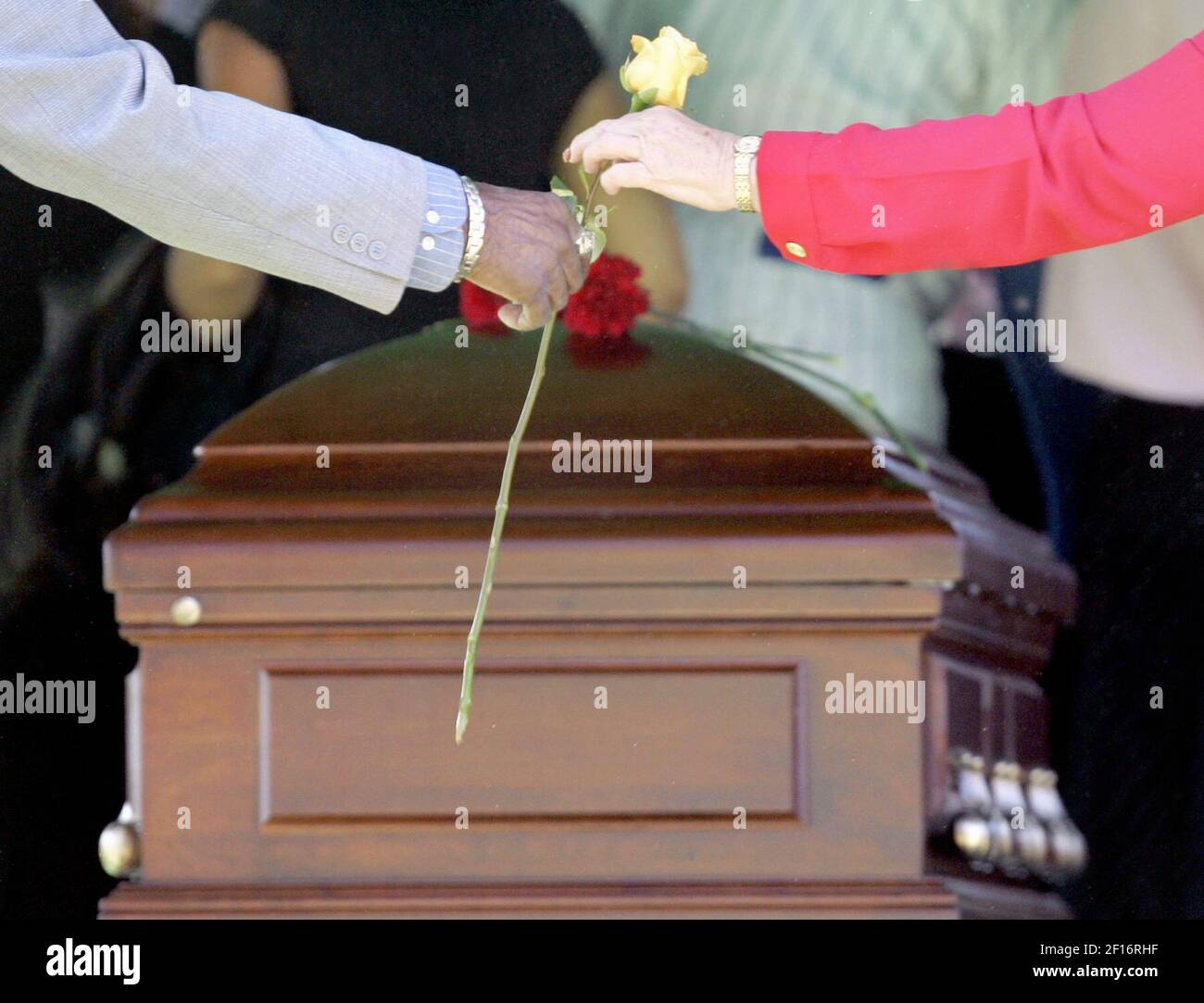 Friends and family gather around the gravesite of John "Buck"O'Neil ...