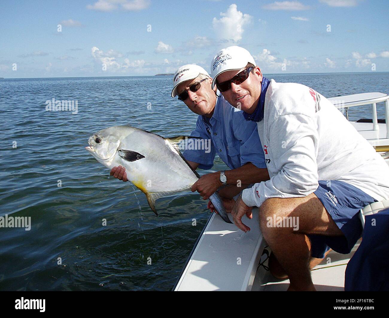 Steve Fleming and captain Greg Poland (foreground) hold a permit that ...