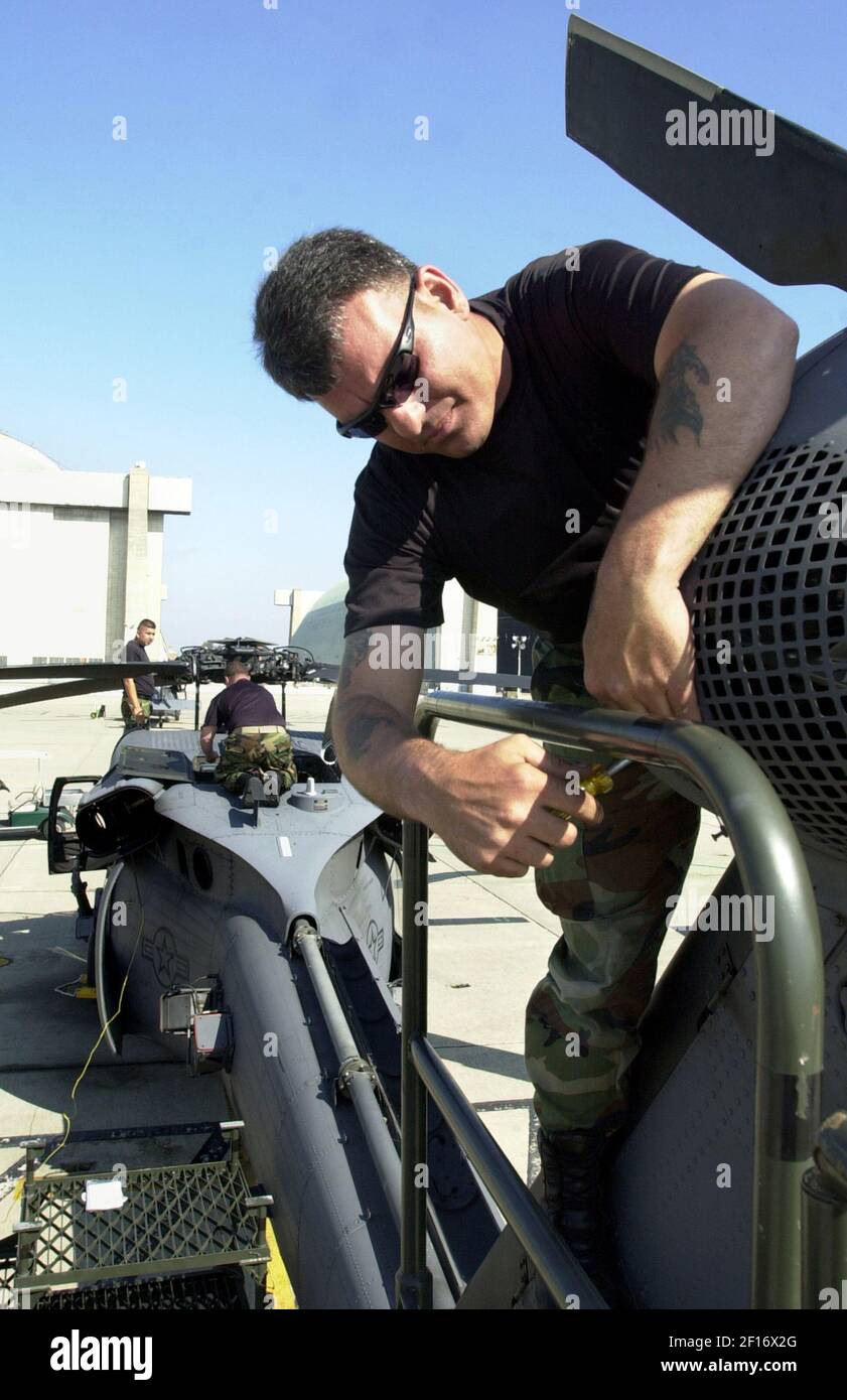 Senior Airman John Anderson performs maintenance on an HH60G Pavehawk ...