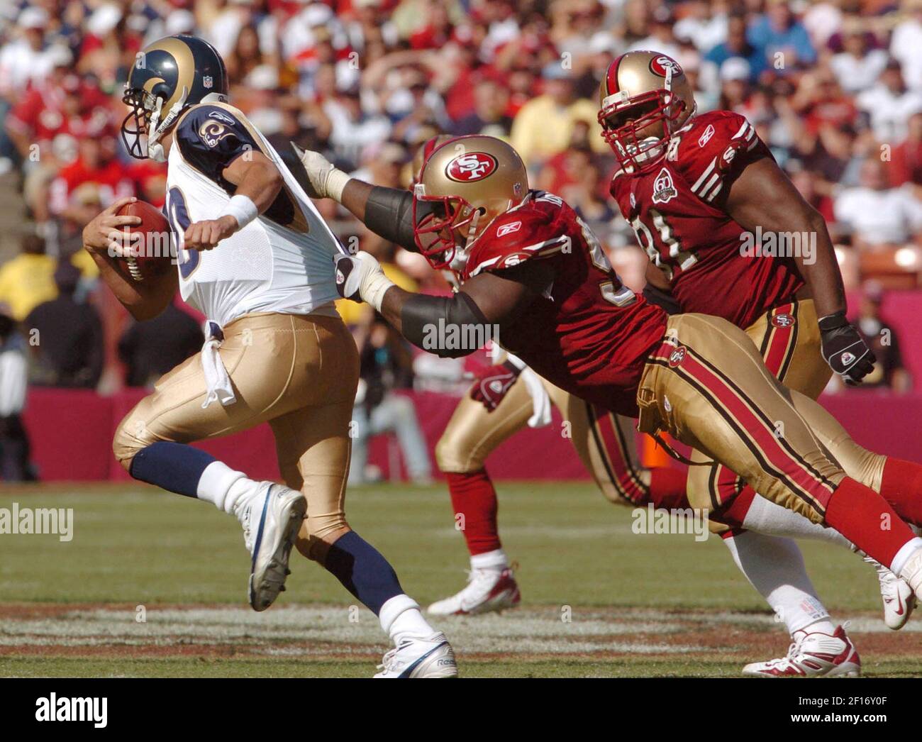 San Francisco 49ers' Bryant Young takes down St. Louis Rams quarterback ...
