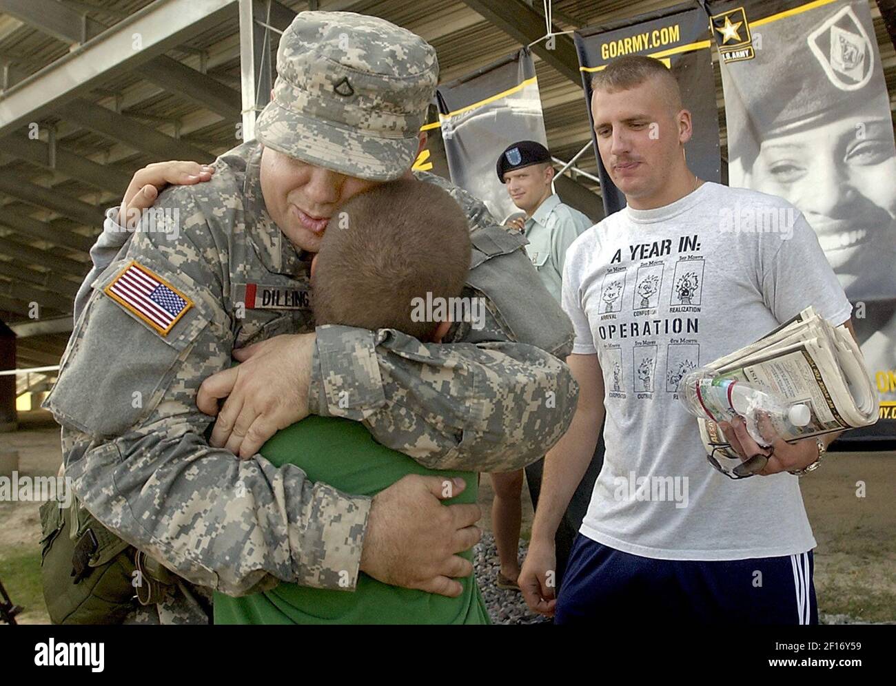 Army Pfc. Russell Dilling, left, gets a hug from his youngest son ...