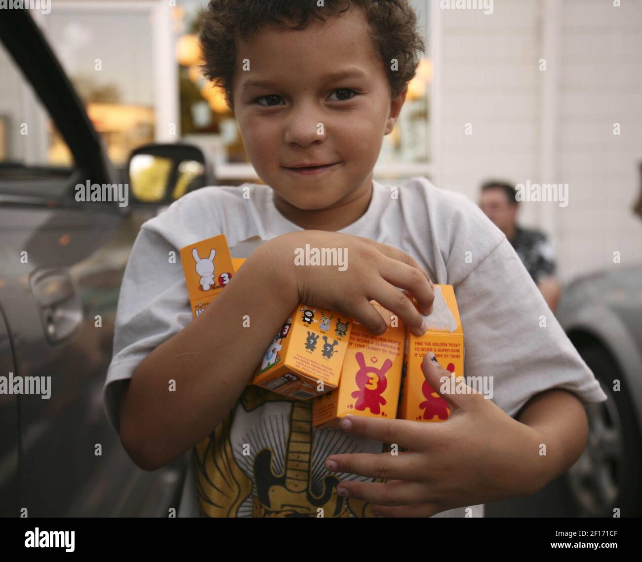 Seven-year-old Jason Crabtree carries an armful of Dunny Series 3 ...