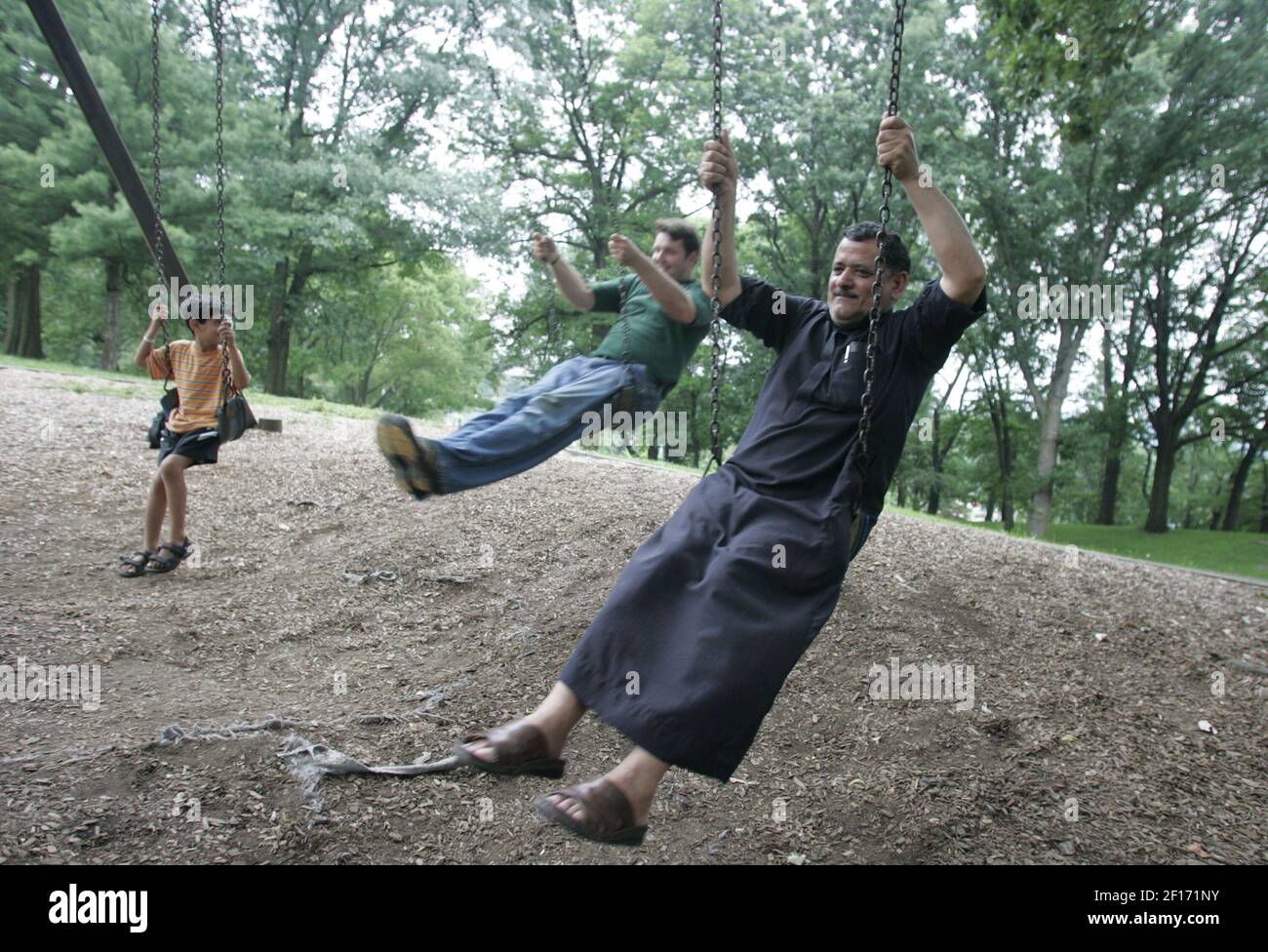 Wearing the traditional Arab Dishdash, Ismael Khalaf Hussein, right ...