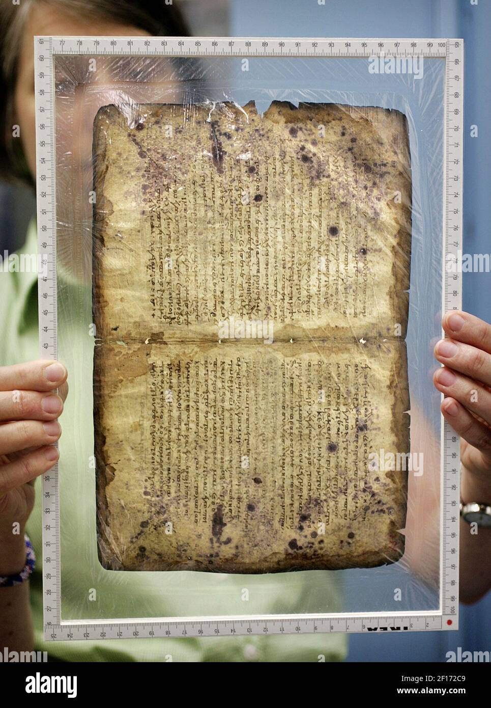 Senior conservator Abigail Quandt prepares to load a goatskin parchment ...