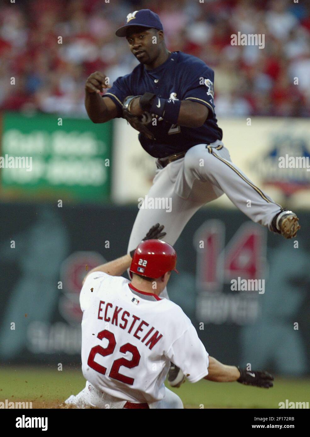 The Milwaukee Brewers' Bill Hall turns a double play over the sliding ...