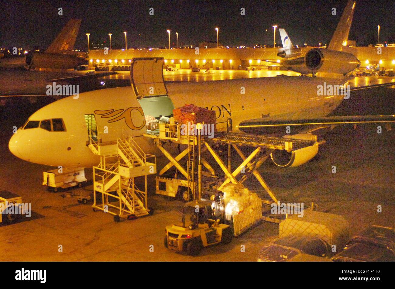 Ramp workers manage the loading of freight onto a cargo plane at Miami ...