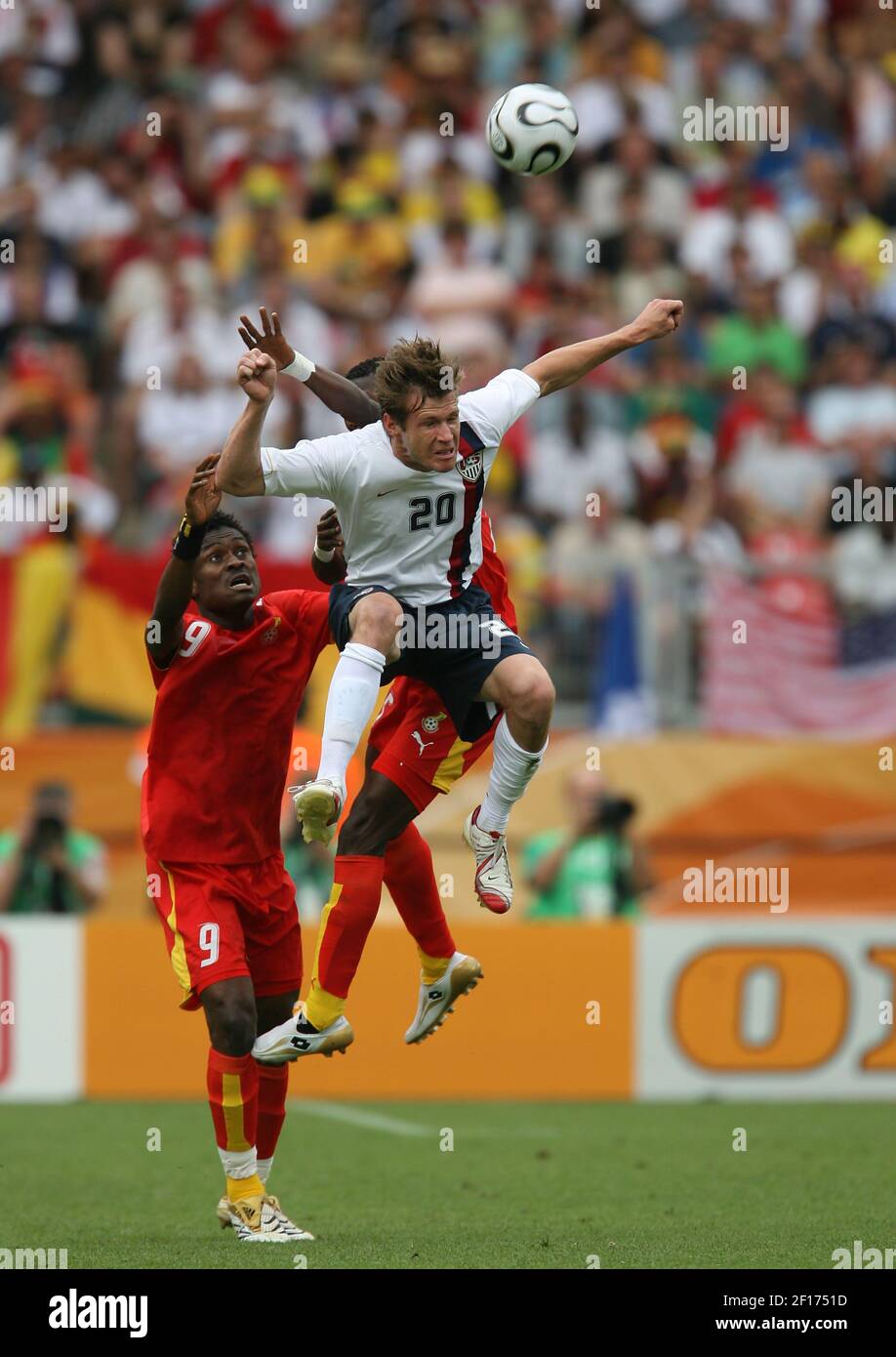 USA's Brian McBride (20) and Ghana's Derek Boateng (9) in action as ...