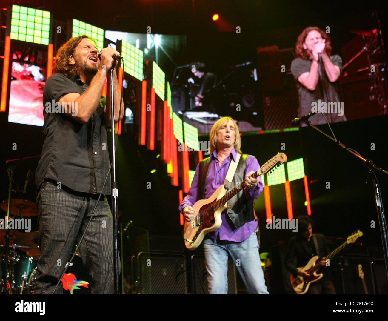 Eddie Vedder, of Pearl Jam, left, performs with Tom Petty and band ...