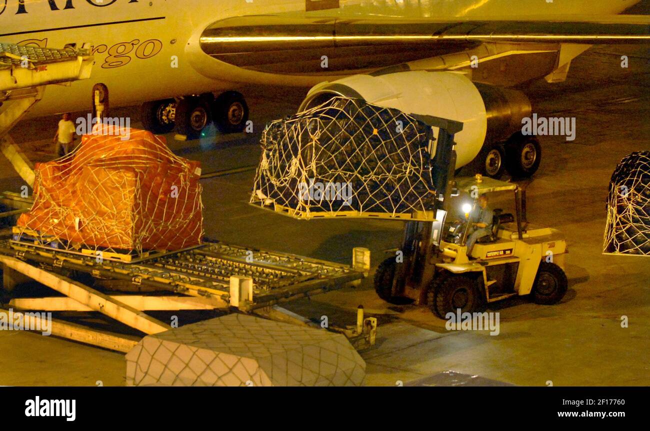 Ramp workers manage the loading of freight onto a cargo plane at Miami ...
