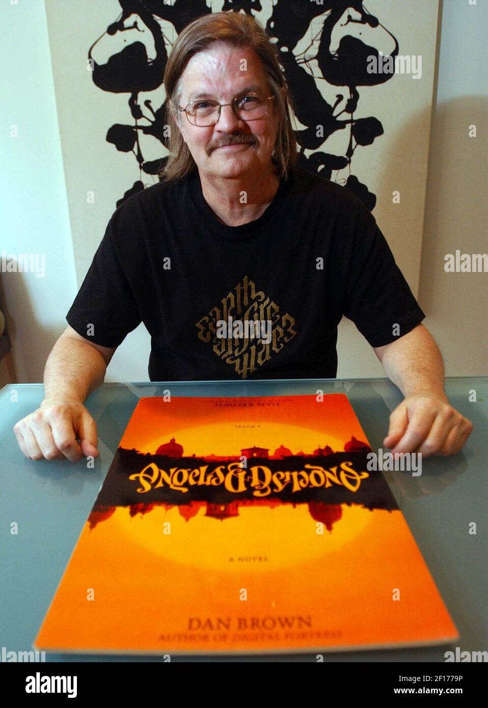 Ambigram artist John Langdon sits before the original cover of Angles ...