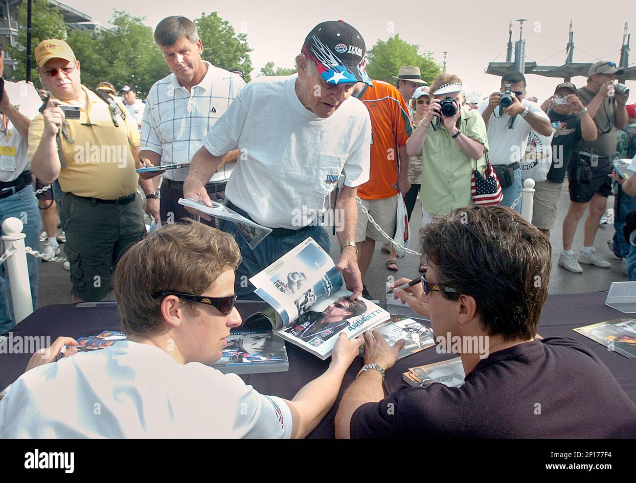 Indy race car drivers Marco, left, and father Michael Andretti sign ...