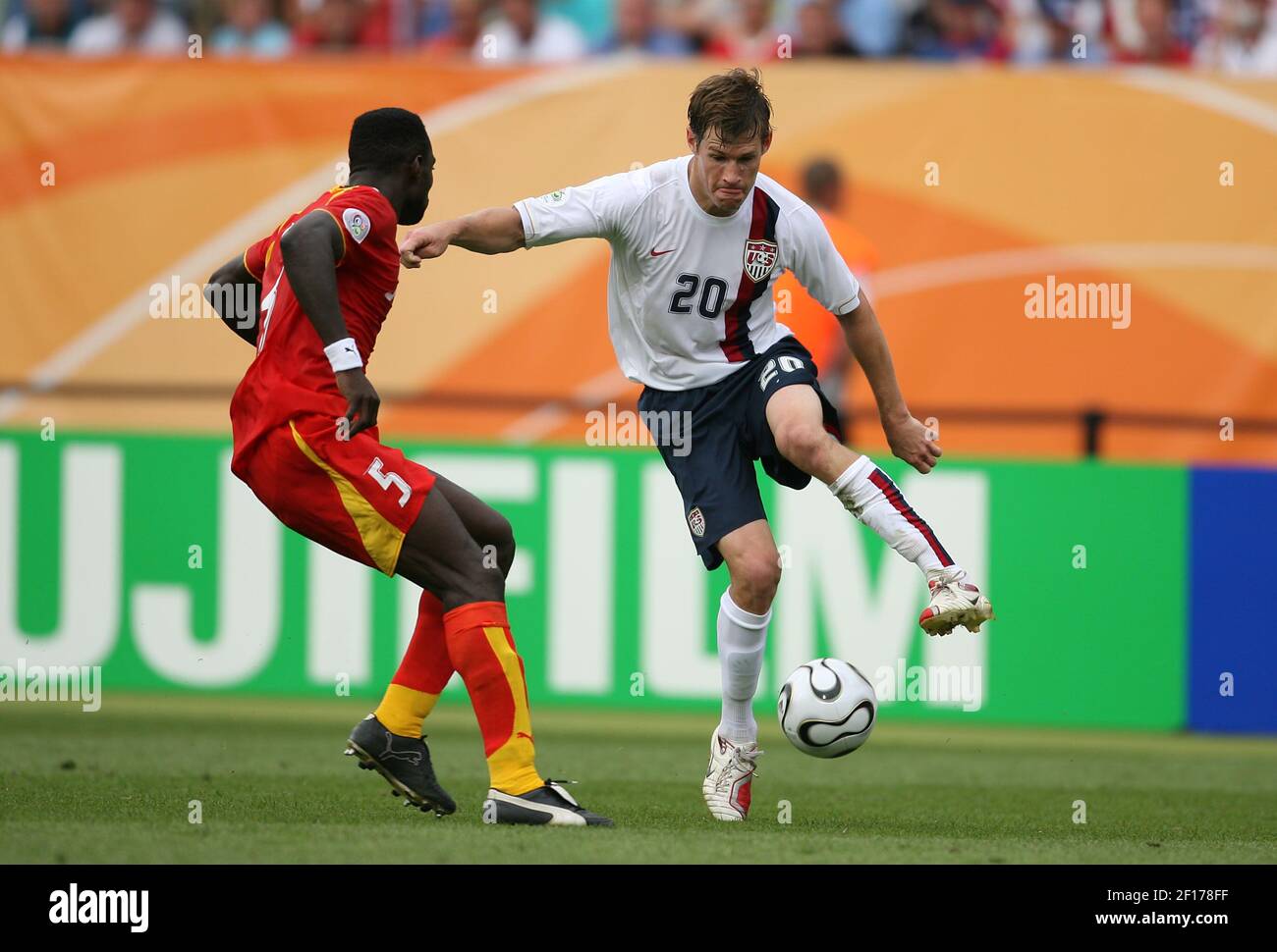 USA's Brian McBride (20) and Ghana's John Mensah (5) as Ghana beat USA ...