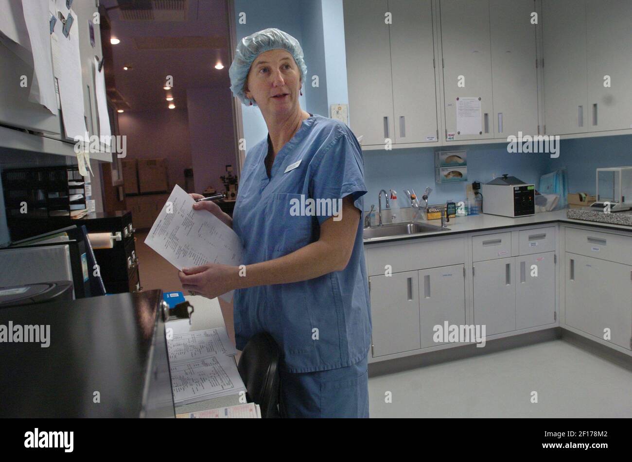 Dr. Kristen Ivani (PhD) checks some paperwork in the IVF Embryology Lab ...