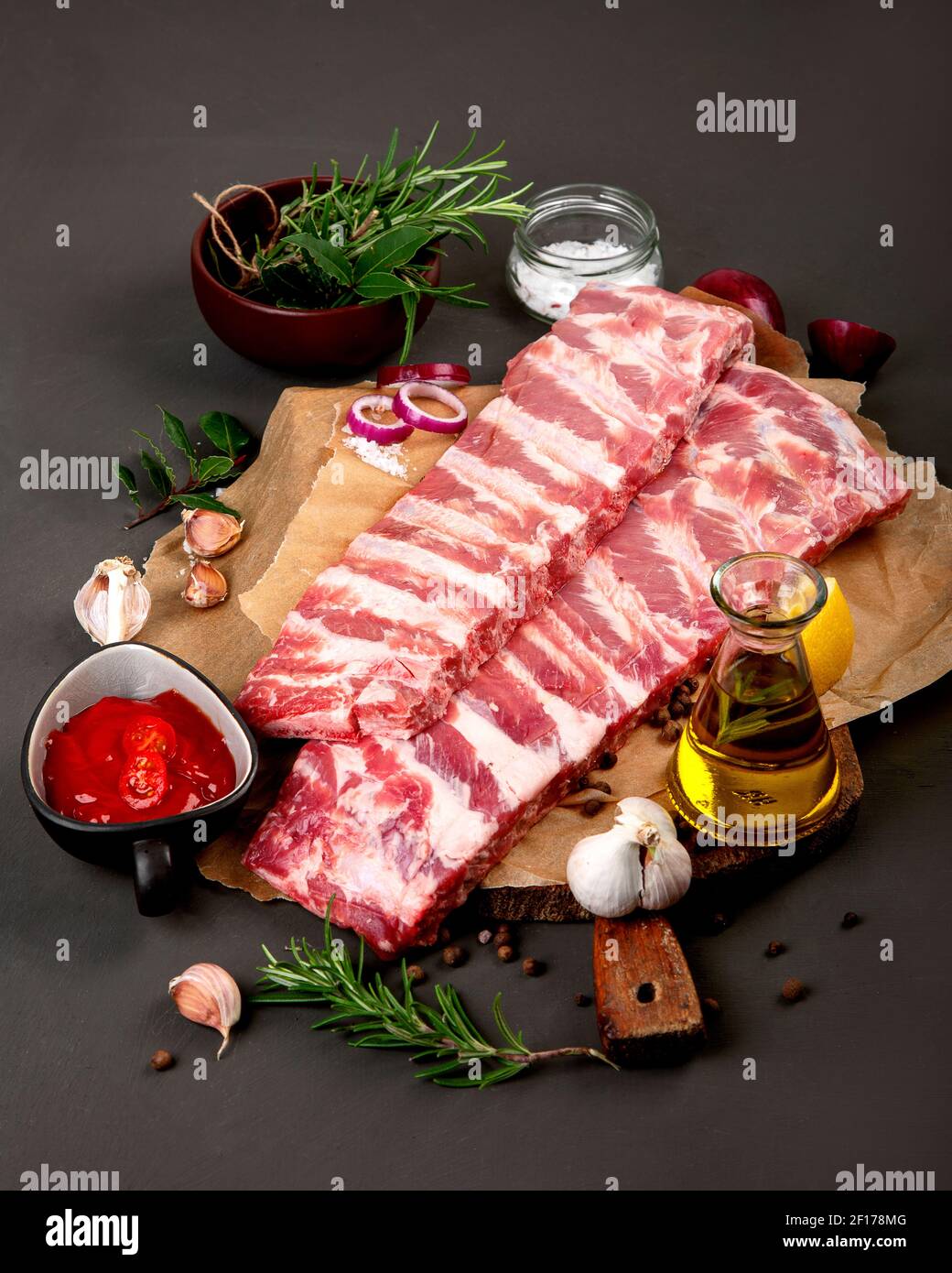 Fresh raw pork ribs seasoned with spices on dark background Stock Photo ...
