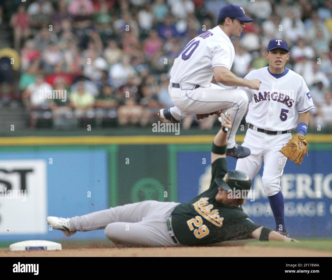 Texas Rangers' shortstop Michael Young gets Oakland Atletics' Dan ...