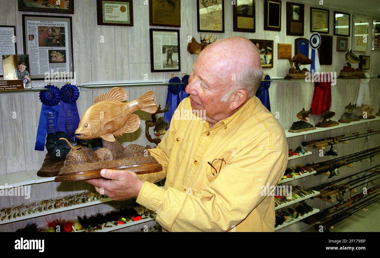 Don Dubin holds up one of his favorite wood carvings in his Lincolnwood ...