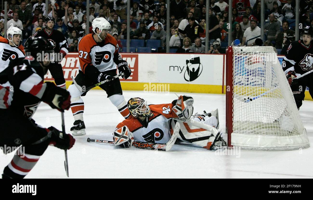 Philadelphia Flyers' goalie Robert Esche watches the puck sail by him ...