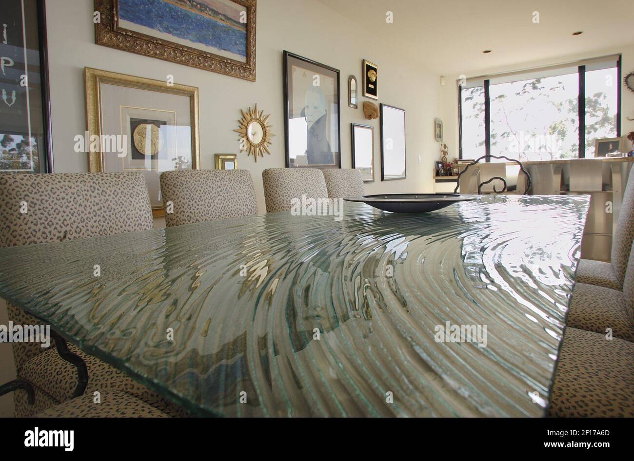 This dining room table is a show piece custom made of cast glass with a ...