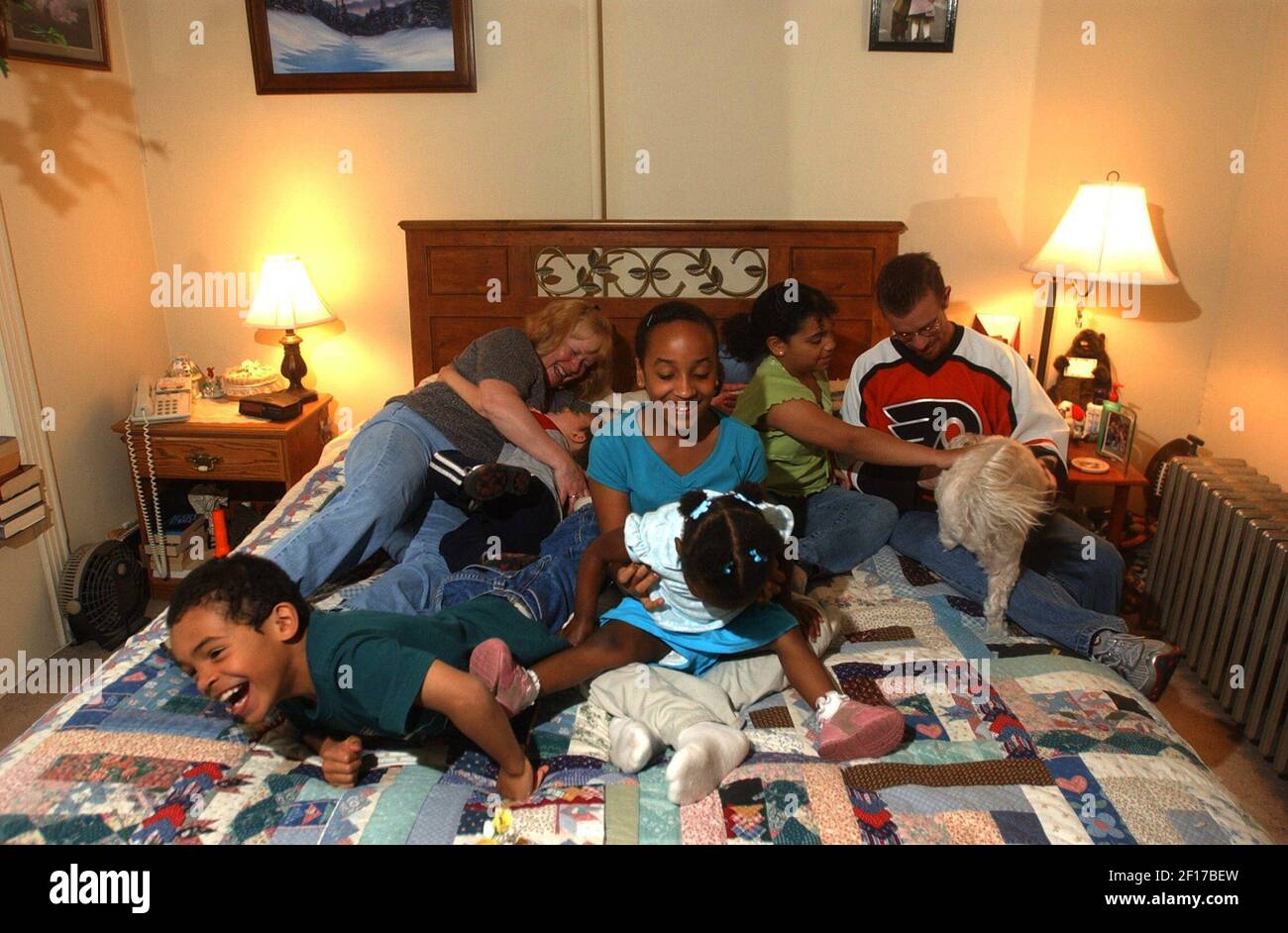 The Stone family hangs out on the parents king size bed with their dog ...