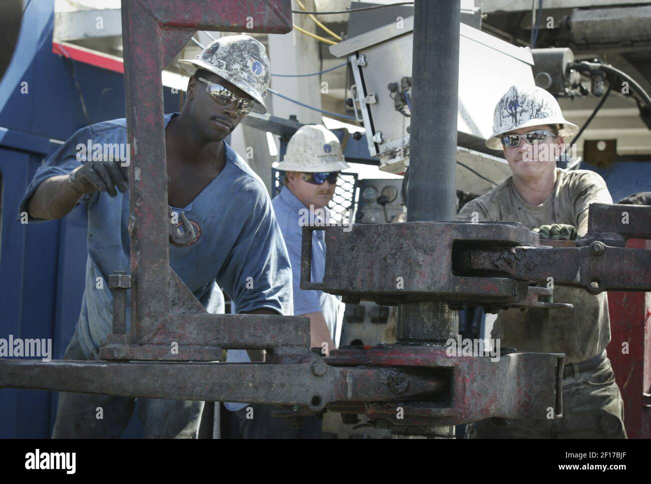 Derrick hand Mack Ross, left, of Tyler, driller Brian Puryear, center ...
