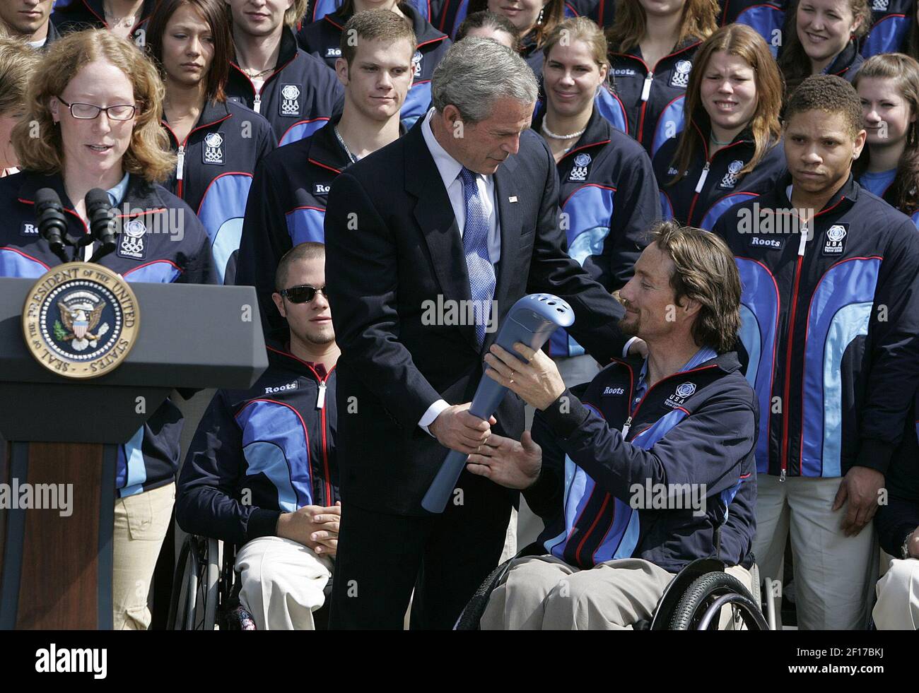 President George W. Bush is presented an Olympic Torch by Paralympics ...