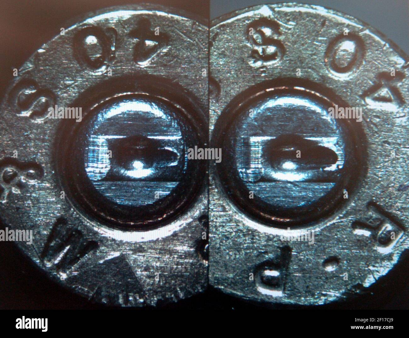 A computer screen shows the firing pin imprint on two shell casings ...