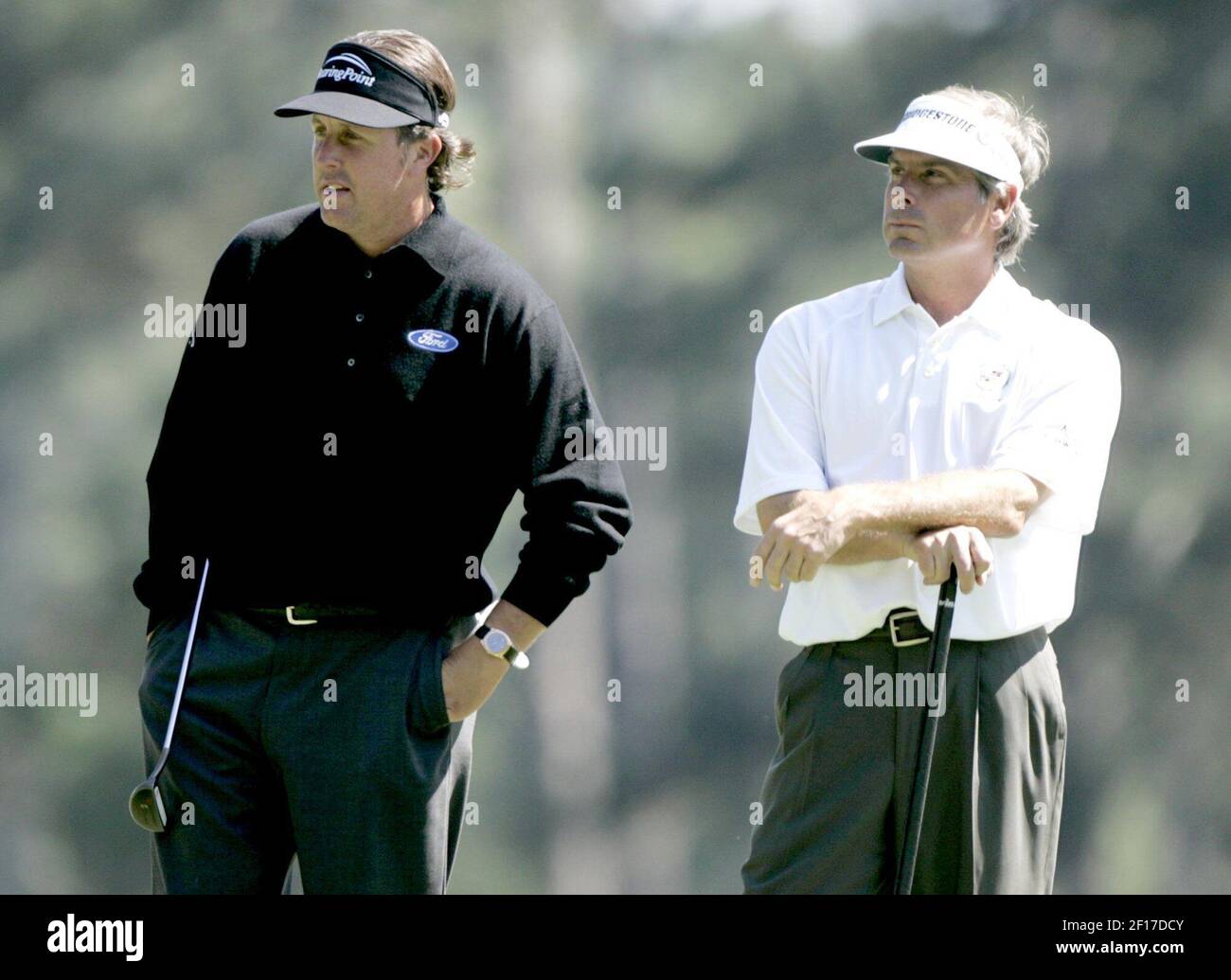 Phil Mickelson, left, and Fred Couples wait to putt at the third green ...