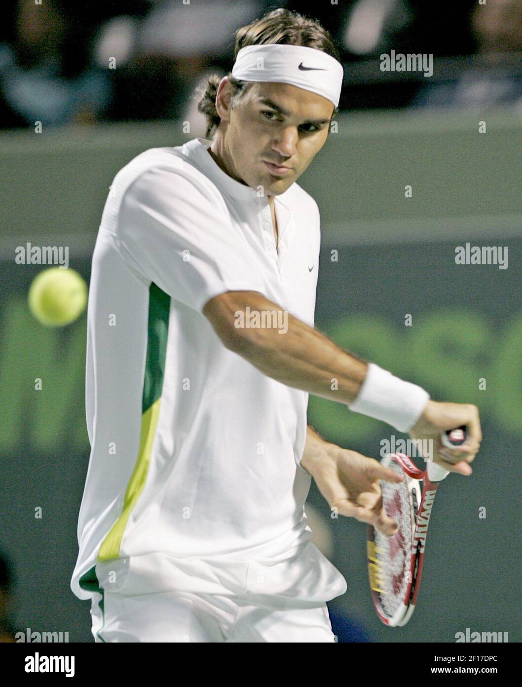 Roger Federer hits a return backhand to David Ferrer in the men's semi ...