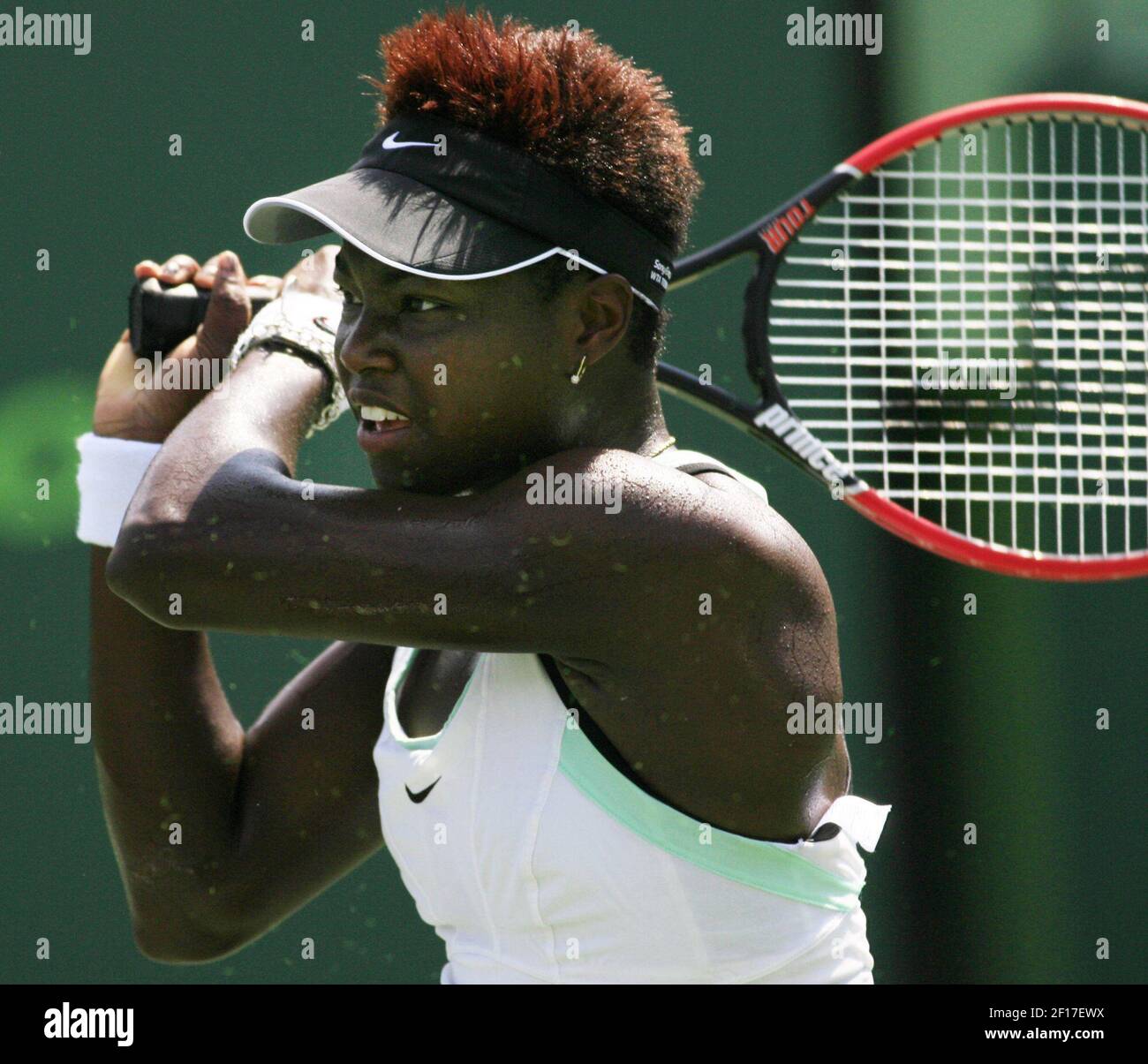 Jamea Jackson hits a shot during her match with Ashely Harkleroad in ...