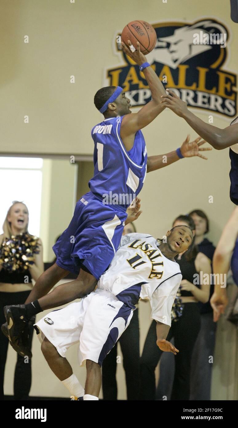 LaSalle's Darnell Harris takes a charge from St. Louis's Danny Brown as ...