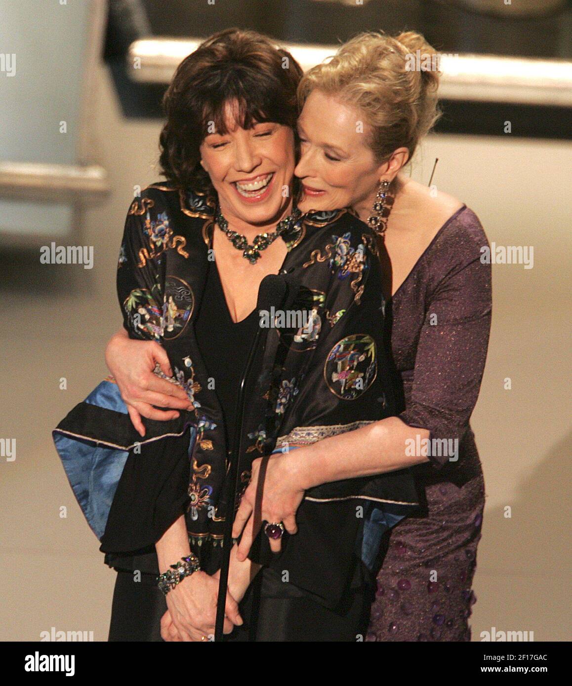 Meryl Streep (right) gives Lily Tomlin a hug before the pair present an ...