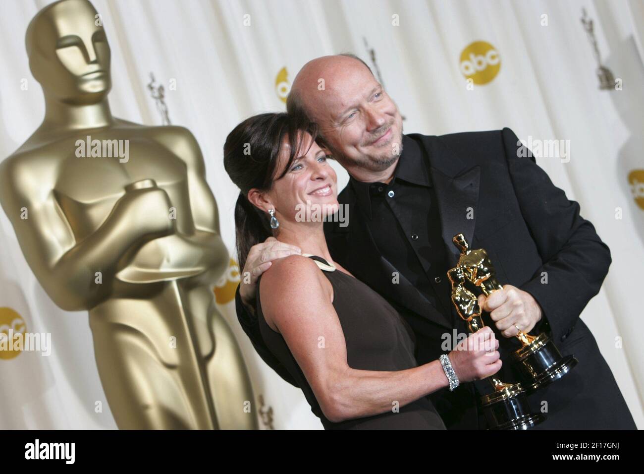 Producers Paul Haggis (right) and Cathy Schulman pose with their Oscars ...