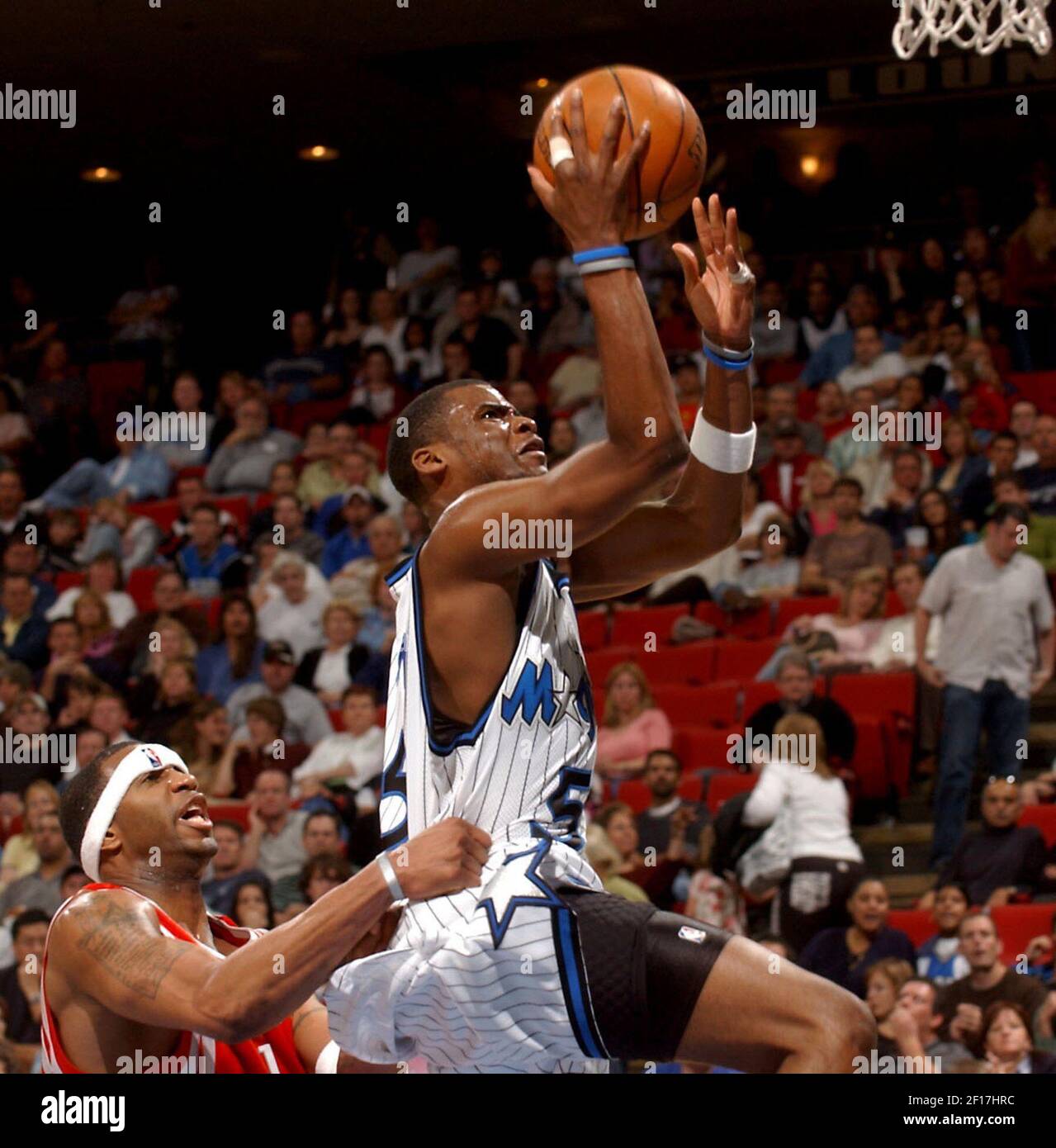 Houston Rockets' Tracy McGrady, left, grabs the jersey of Orlando Magic ...