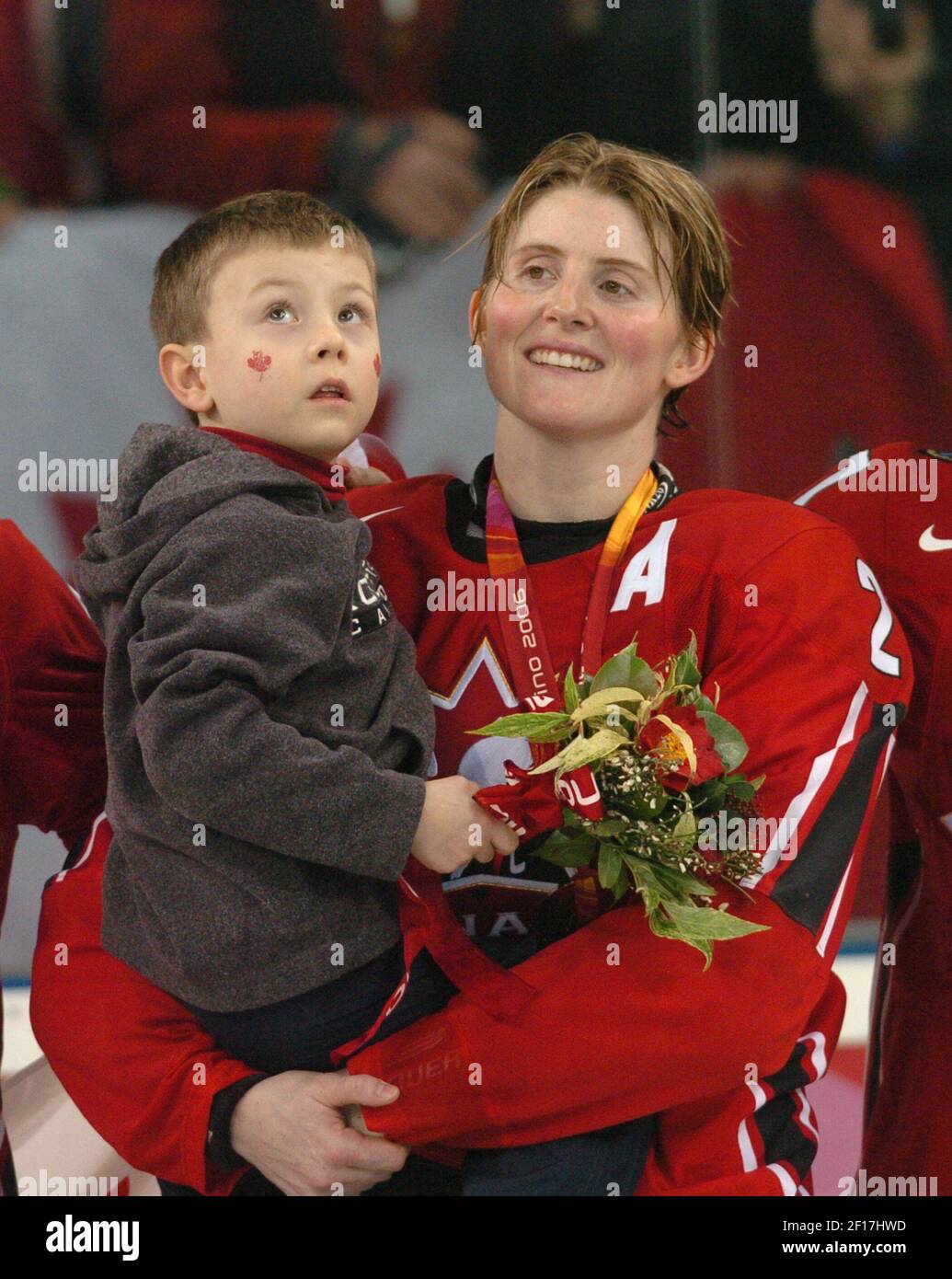 Hayley Wickenheiser holds her stepson Noah during the medals ceremony ...