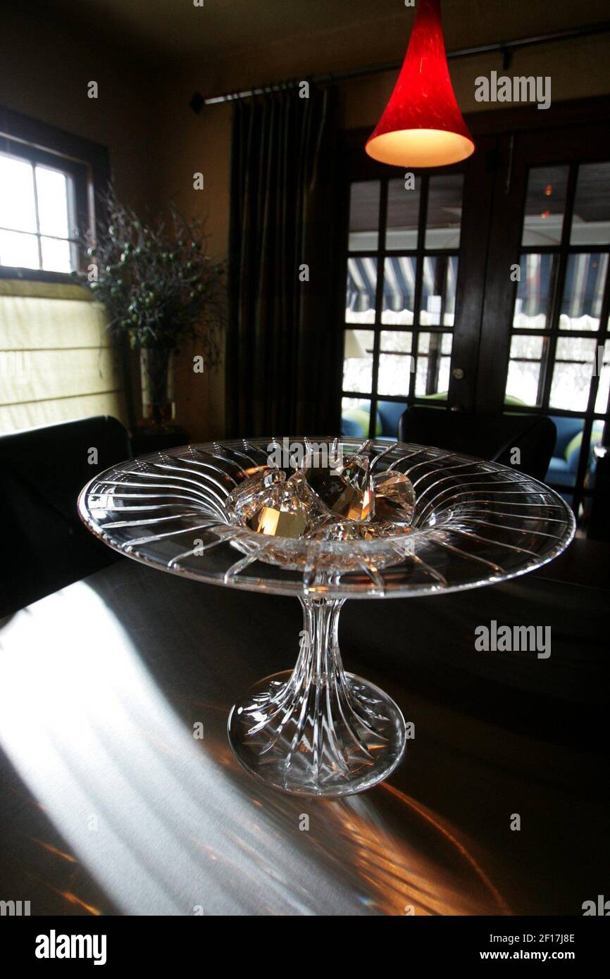 A crystal centerpiece sits on a table in a dining room that interior ...
