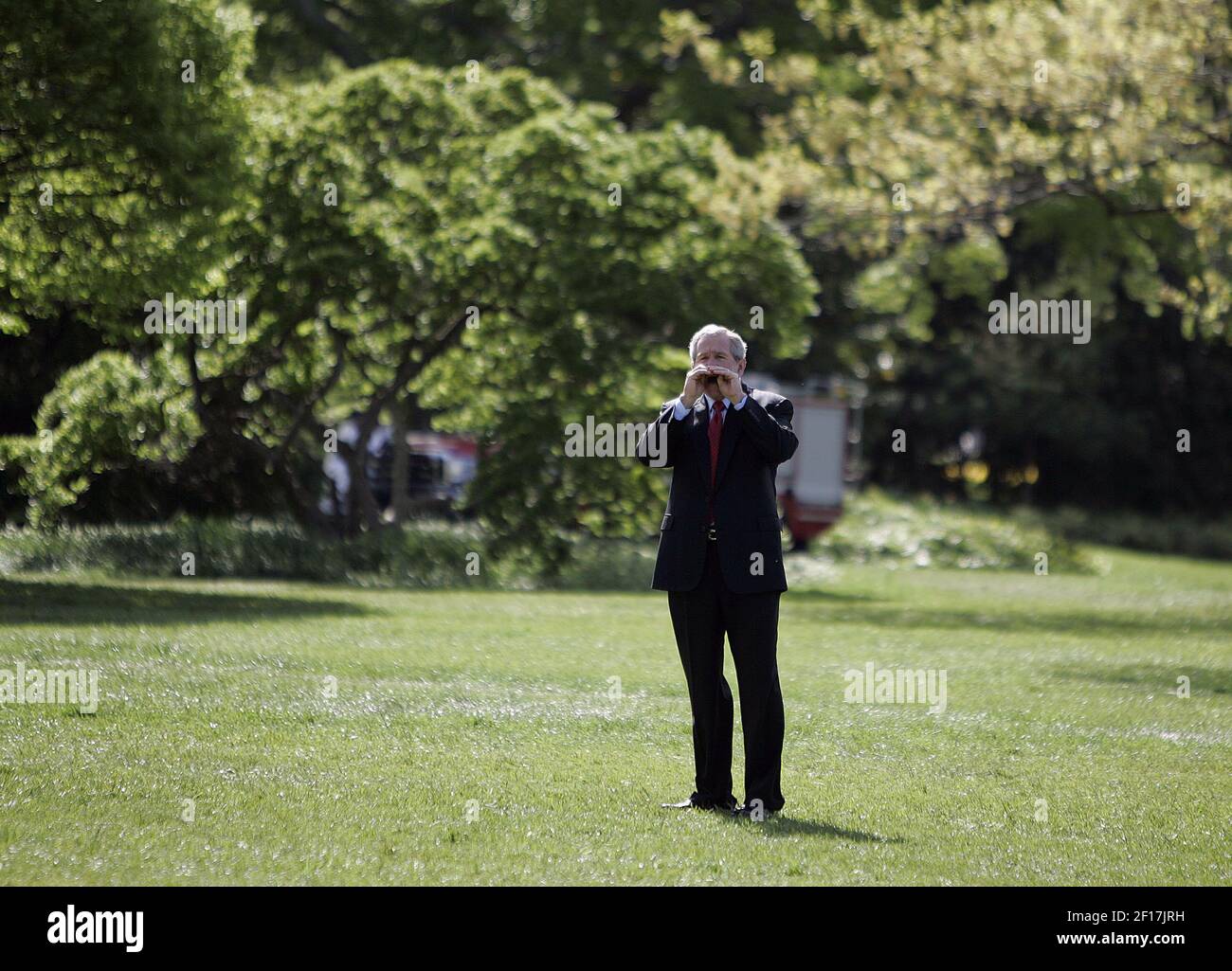 President George W. Bush yells to the media on the South Lawn of the ...
