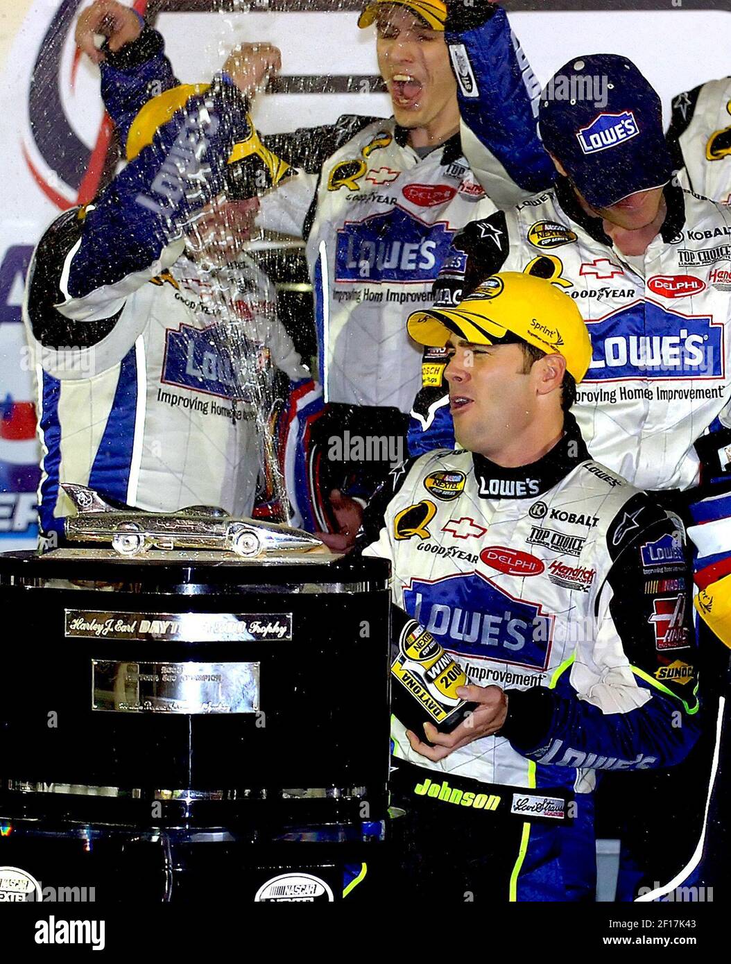 NASCAR NEXTEL Cup driver Jimmie Johnson (48) sprays champagne as he ...