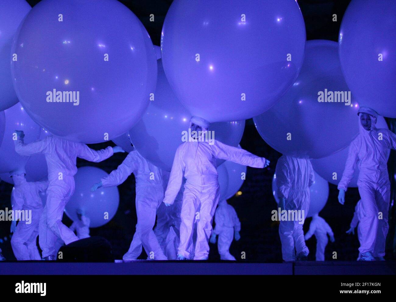 Performers on stage with huge white balloons representing snowflakes at ...
