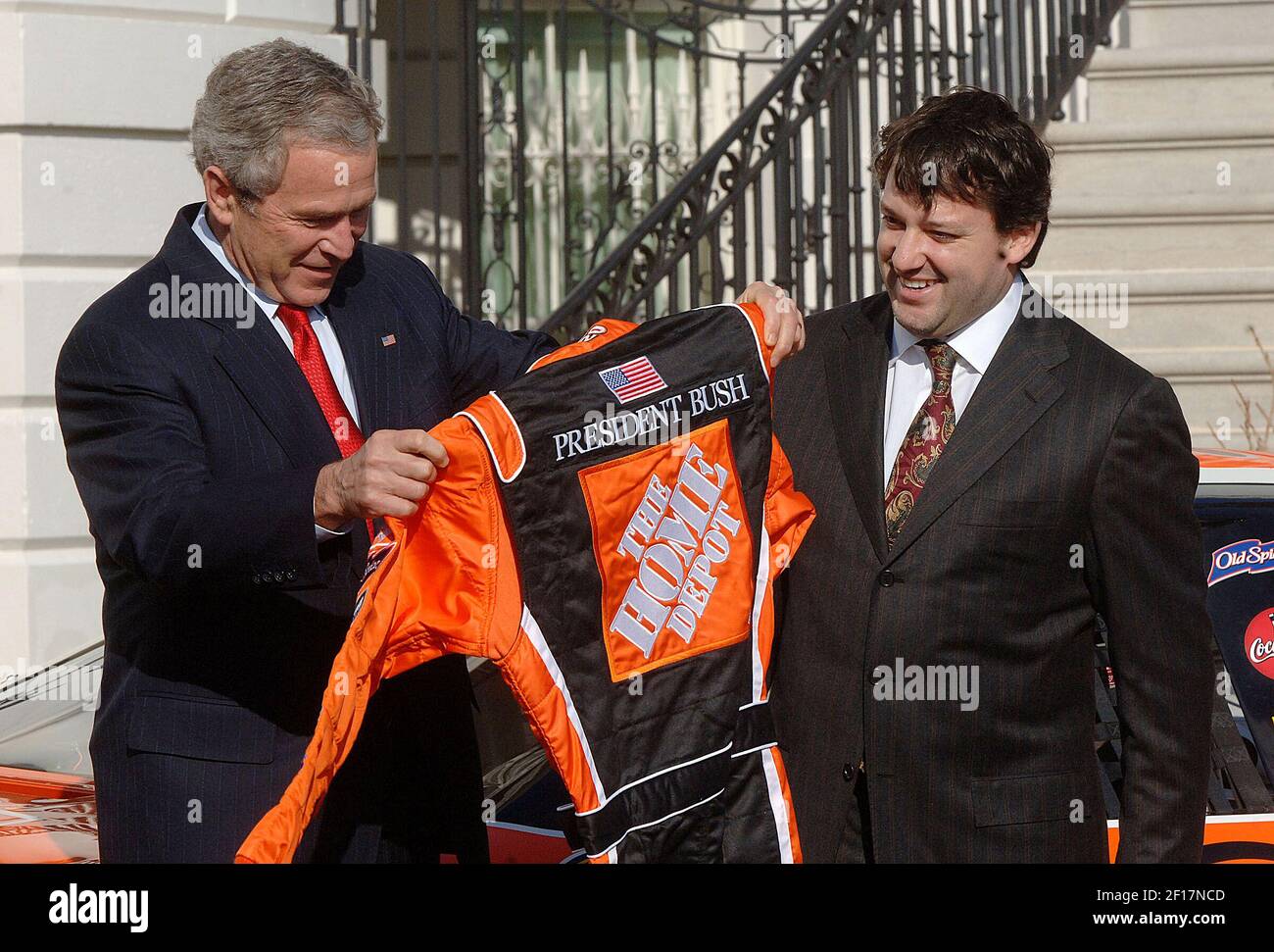 U.S. President George W. Bush holds a Joe Gibbs Racing jumpsuit by 2005 ...