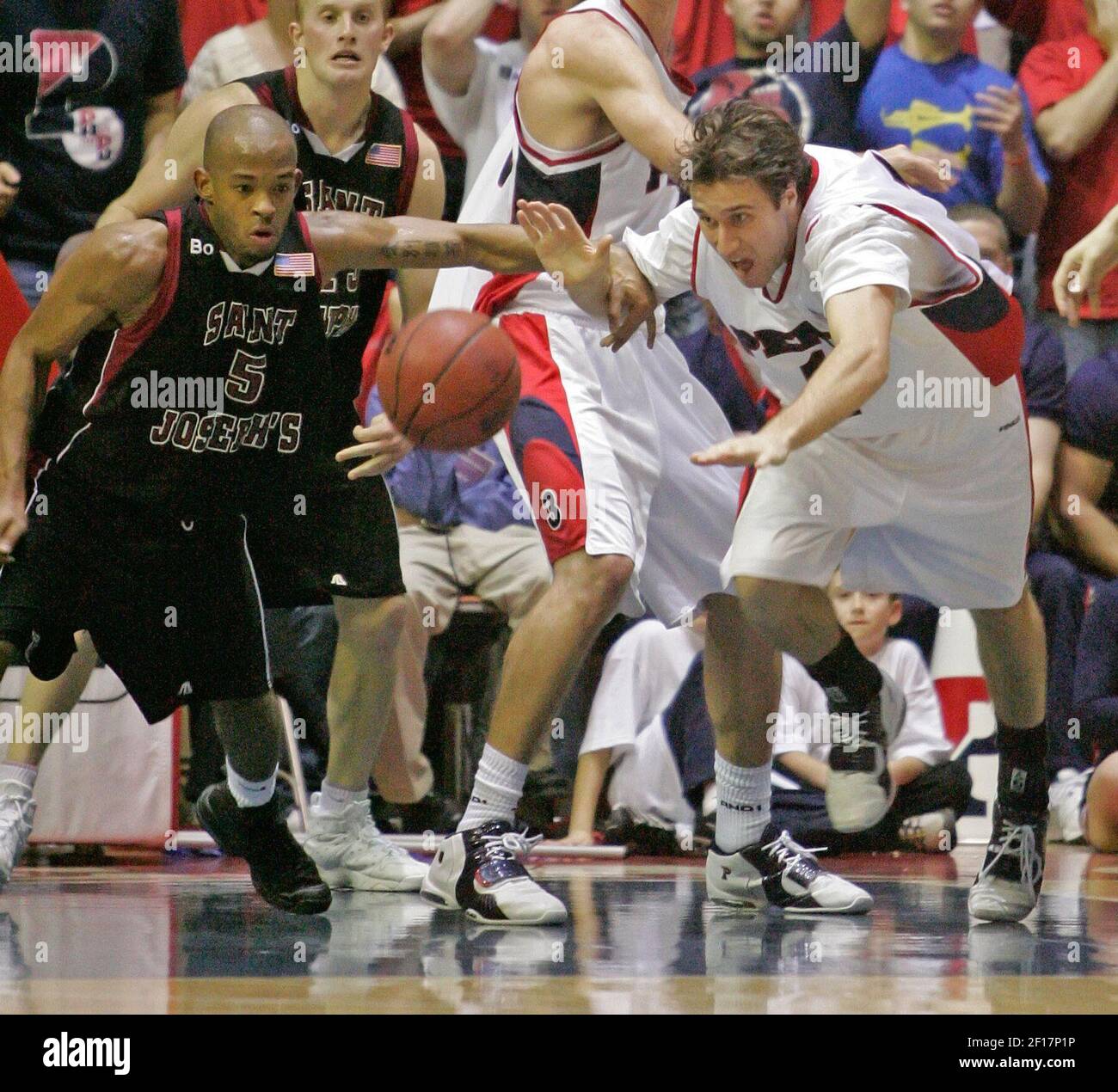 St. Joseph's Dwayne Lee, left, and Penn's Brian Grandieri both eye a ...