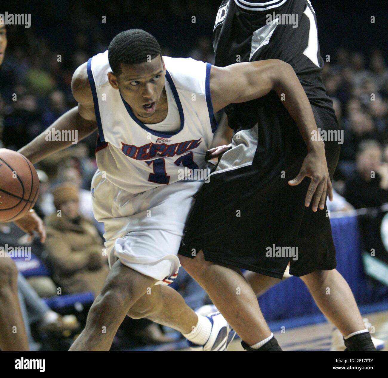 DePaul's Sammy Mejia dribbles around Providence's Geoff McDermott ...