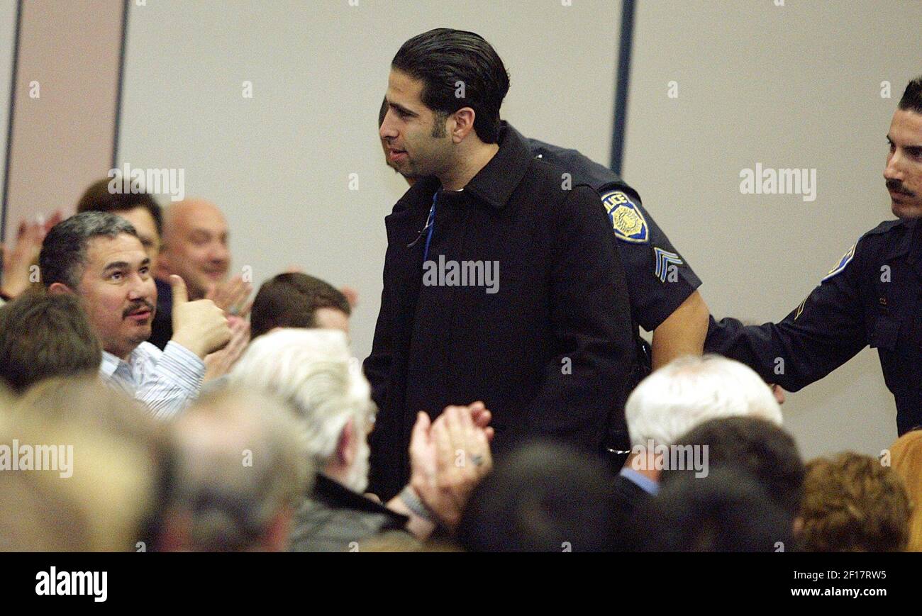 Pedro Renteria, left, gives a thumbs up to police as they escort an ...