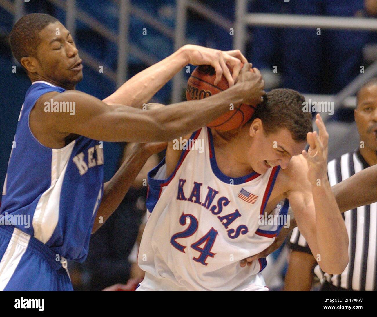 Kentucky's Ravi Moss, left, fouls Kansas' Sasha Kaun in the Jayhawks 73 ...