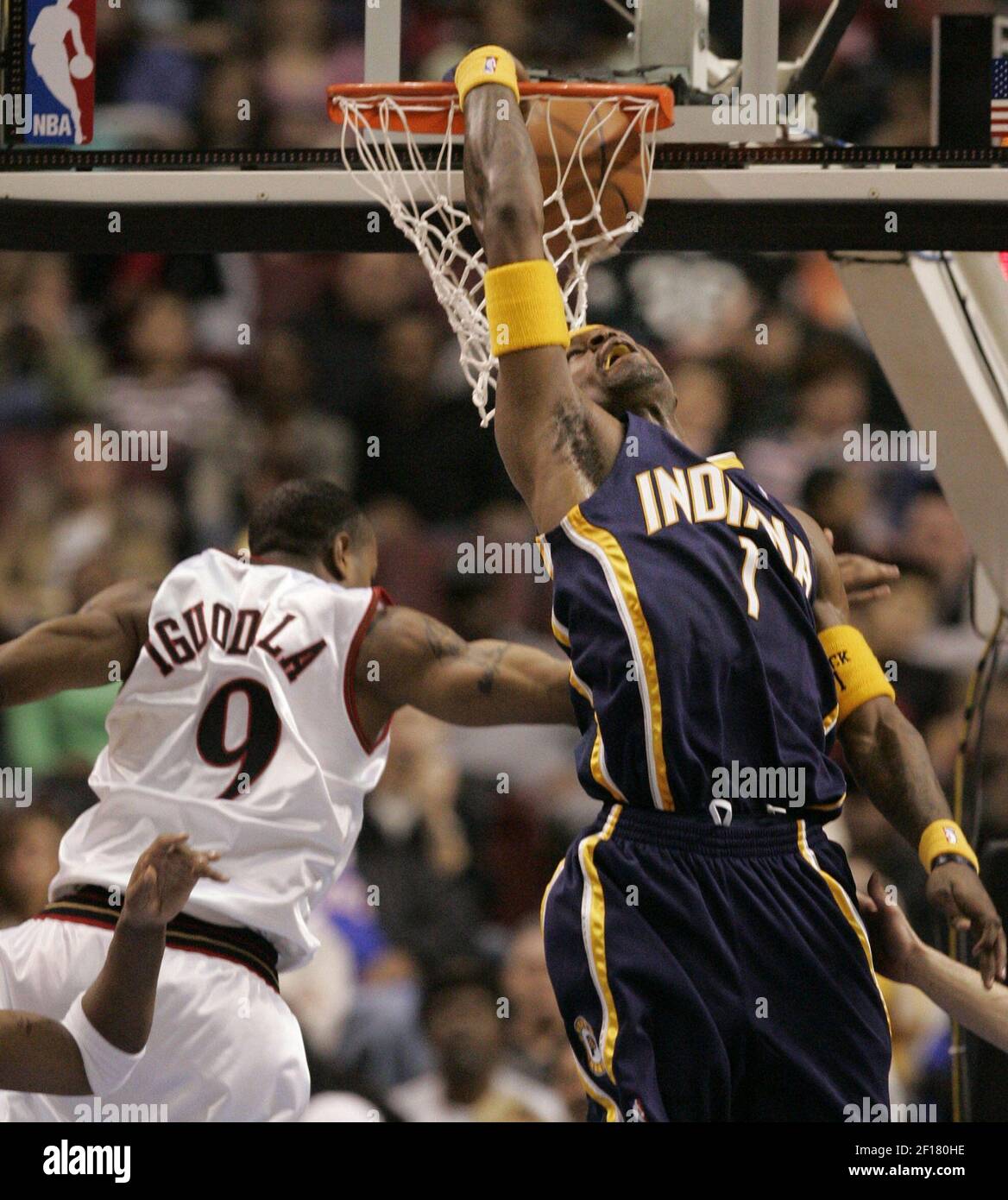 Indiana Pacers' Stephen Jackson (right) dunks over Andre Iguodala of ...