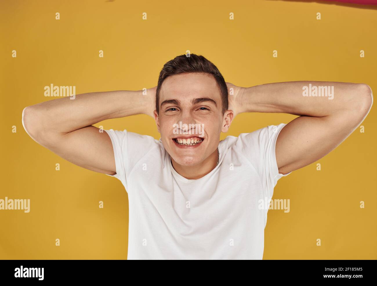 Happy guy gestures with his hands fun emotions model yellow background ...