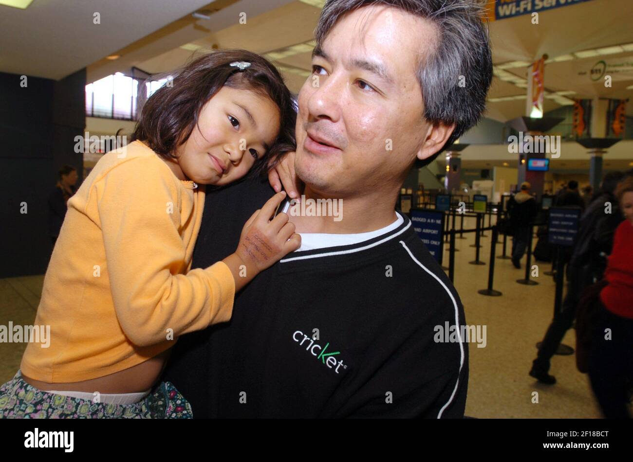 Elizabeth Frey, 3, is held by her father Lance before boarding a flight ...